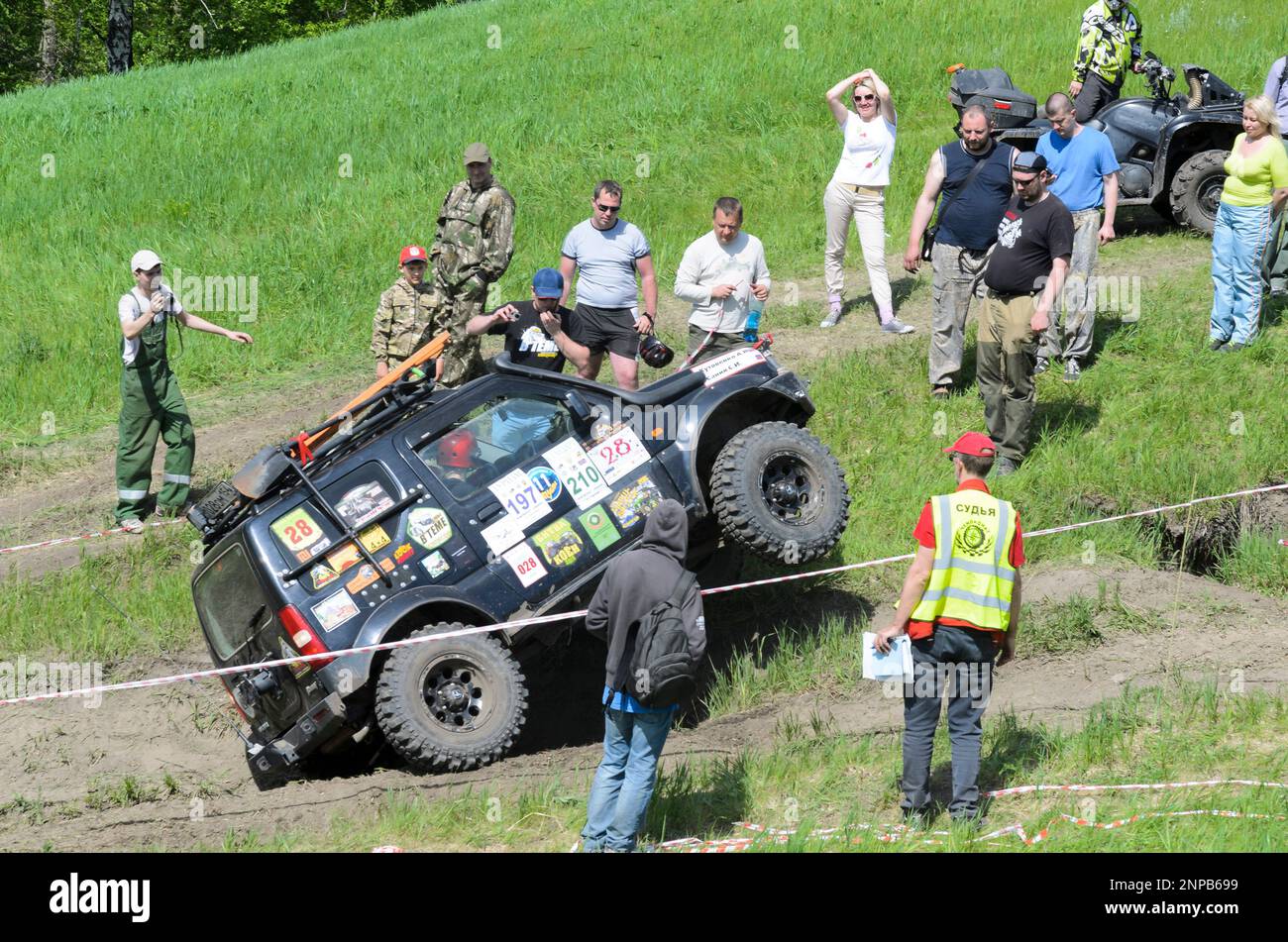 Crowd of spectators looking at the car "Suzuki Escudo" which is highly ...