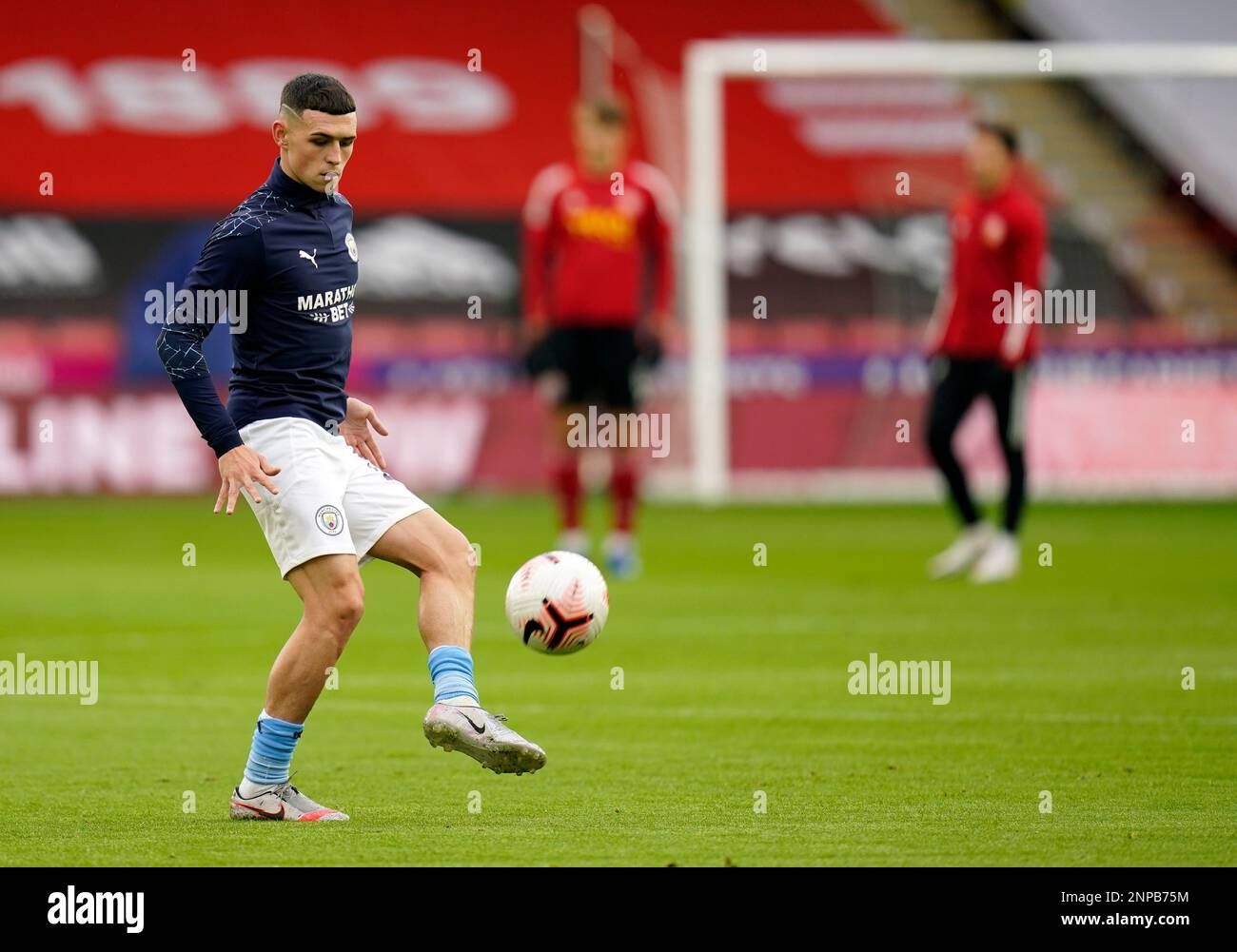 Manchester City's Phil Foden kicks a ball during warmup before the ...