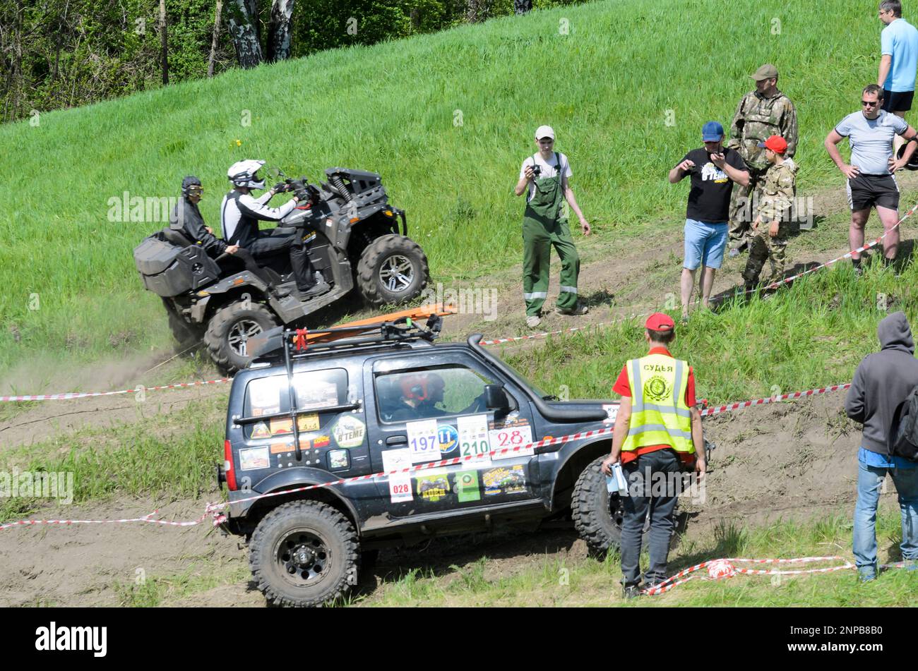 Crowd of spectators looking at the car "Suzuki Escudo" which is highly ...