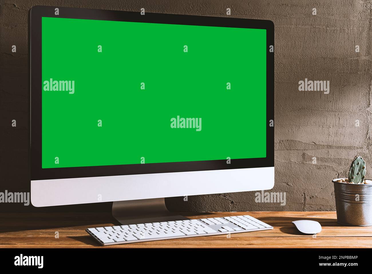 Chroma key green screen computer on table with keyboard, mouse and ...