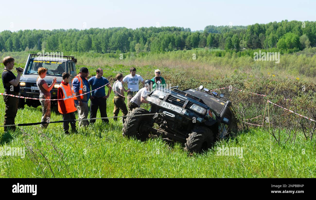 Crowd of spectators looking at the car "Suzuki Escudo" which is highly ...