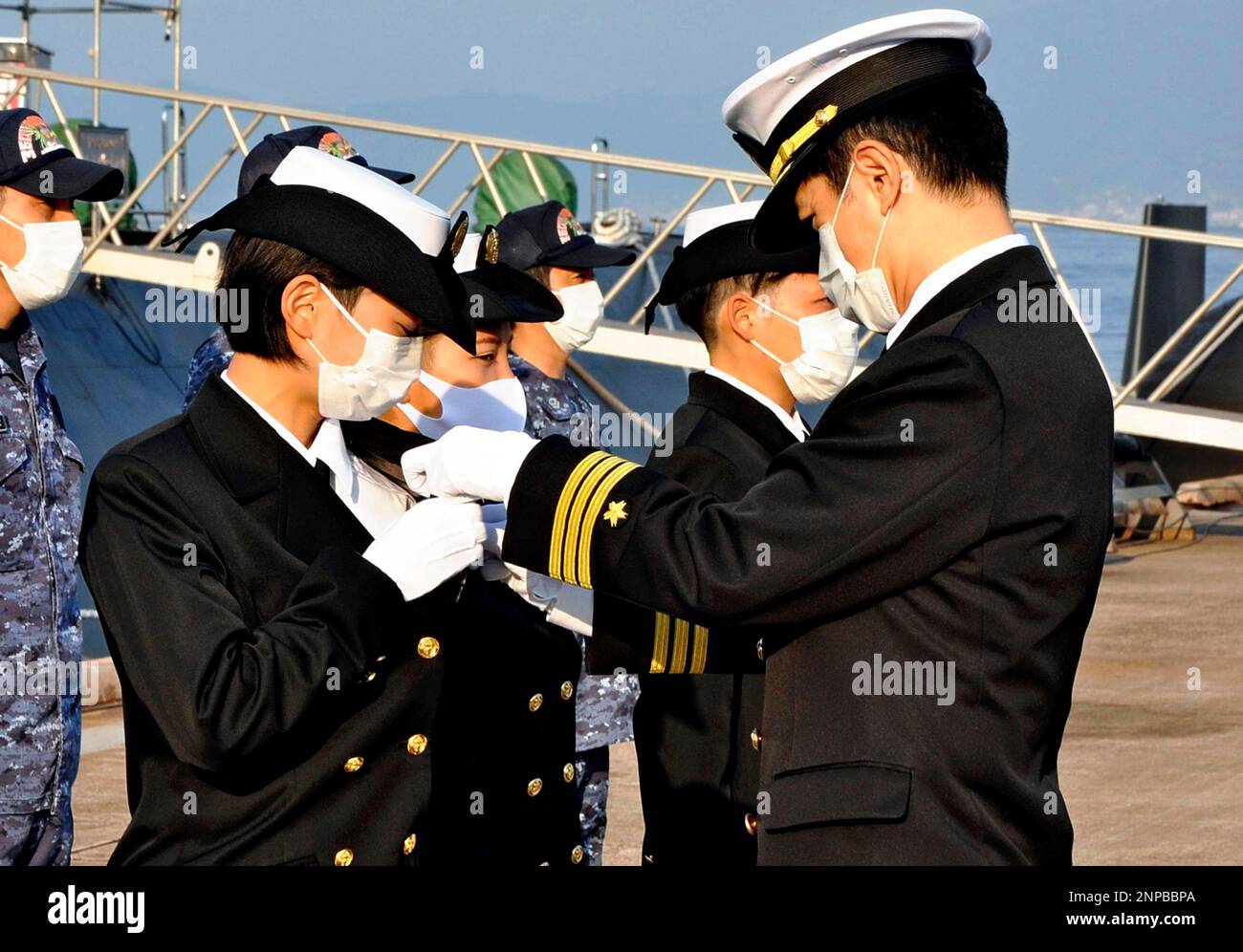 A female personnel of Japan's Maritime Self-Defense Force receives a ...