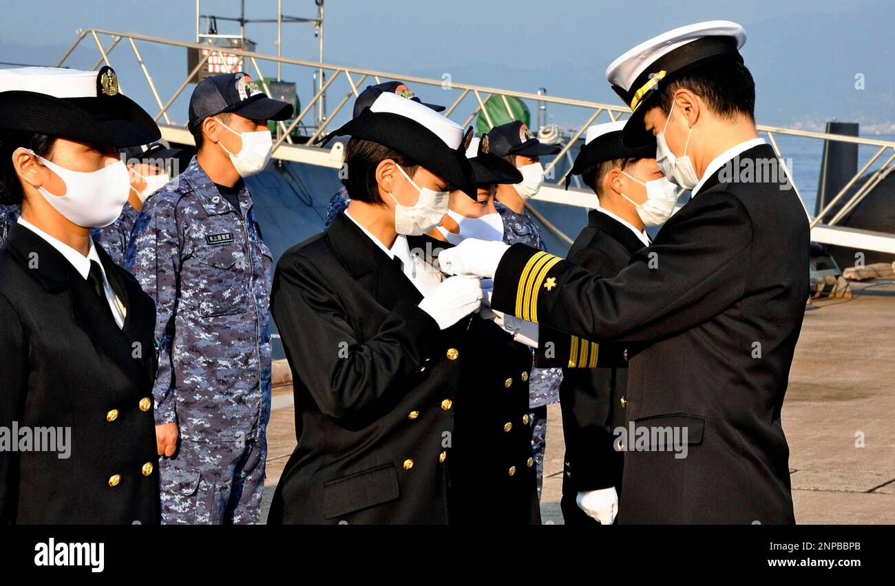 A female personnel of Japan's Maritime Self-Defense Force receives a ...