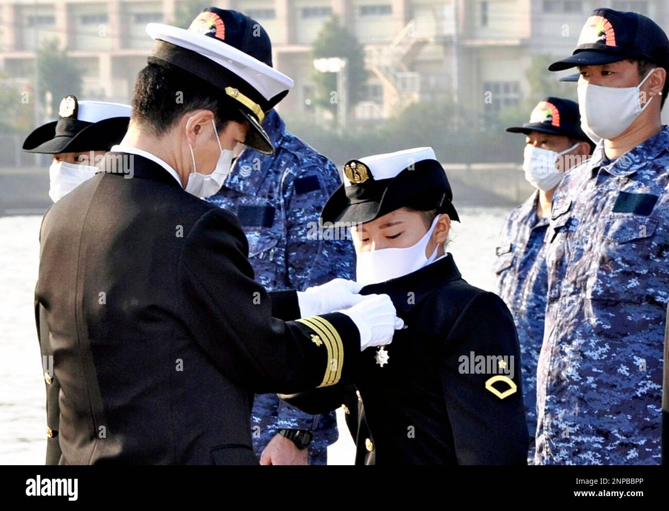 A female personnel of Japan's Maritime Self-Defense Force receives a ...