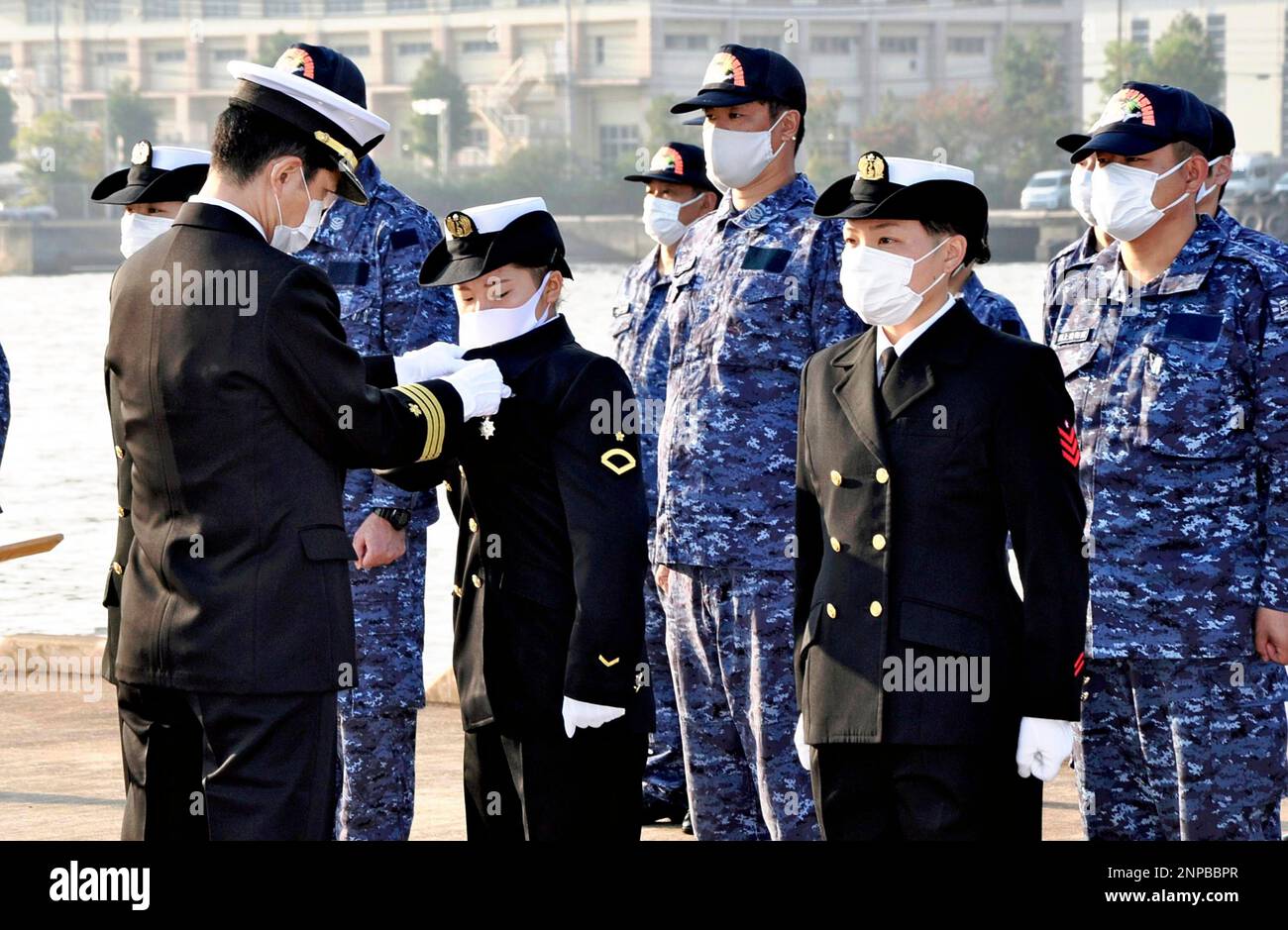 A female personnel of Japan's Maritime Self-Defense Force receives a ...