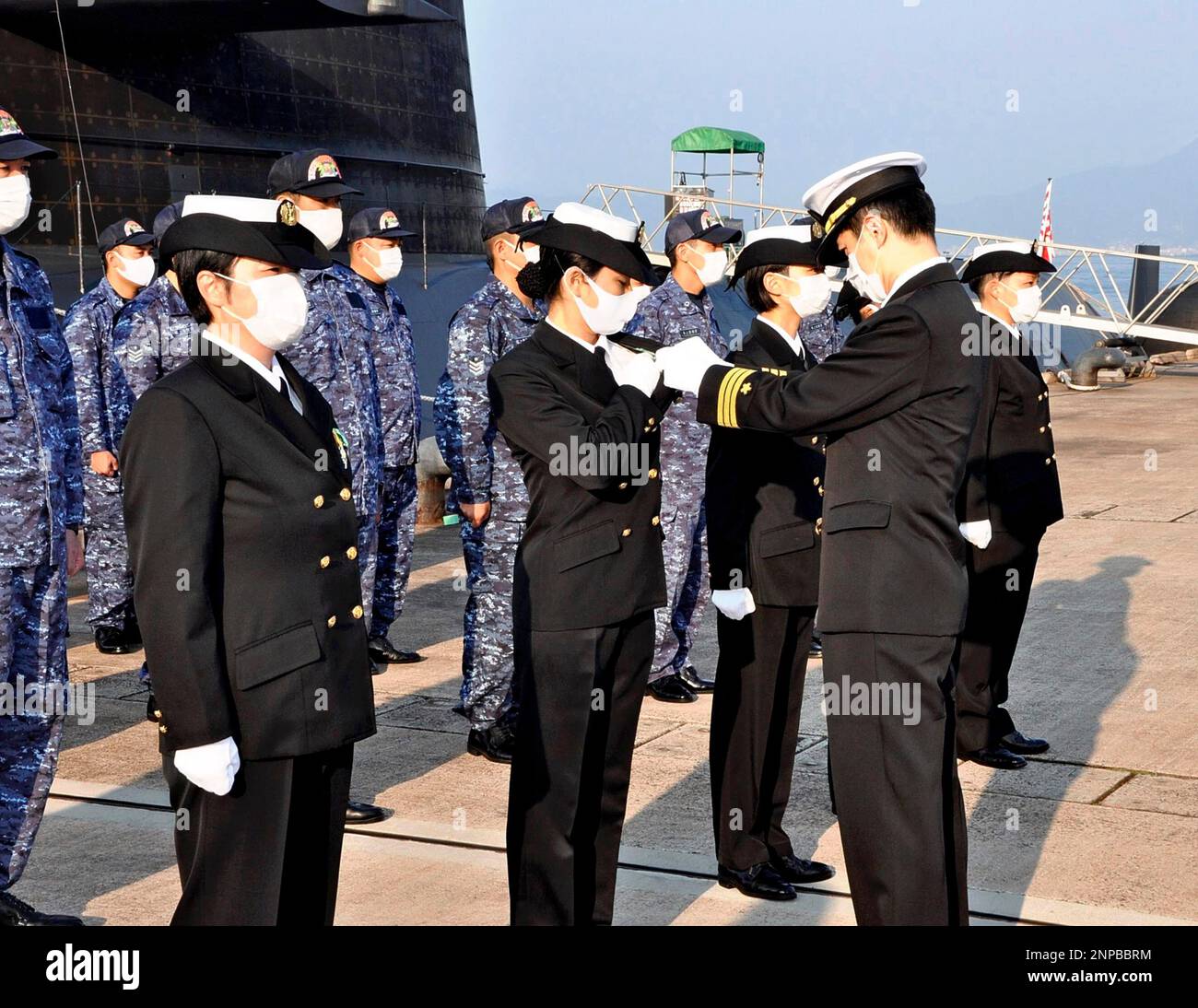 A female personnel of Japan's Maritime Self-Defense Force receives a ...