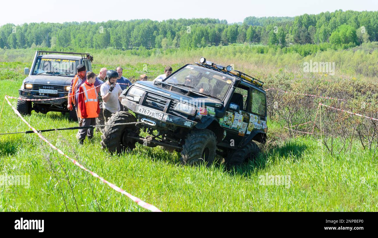 Crowd of spectators looking at the car "Suzuki Escudo" which is highly ...