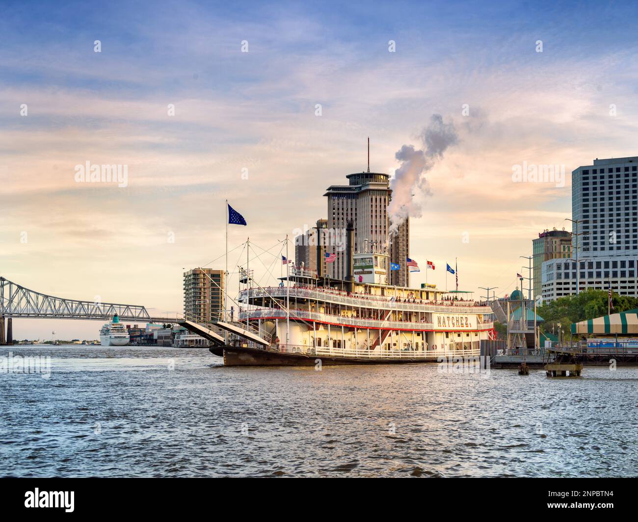 Natchez Steamboat at the Mississippi River and Boardwalk, sunset New ...