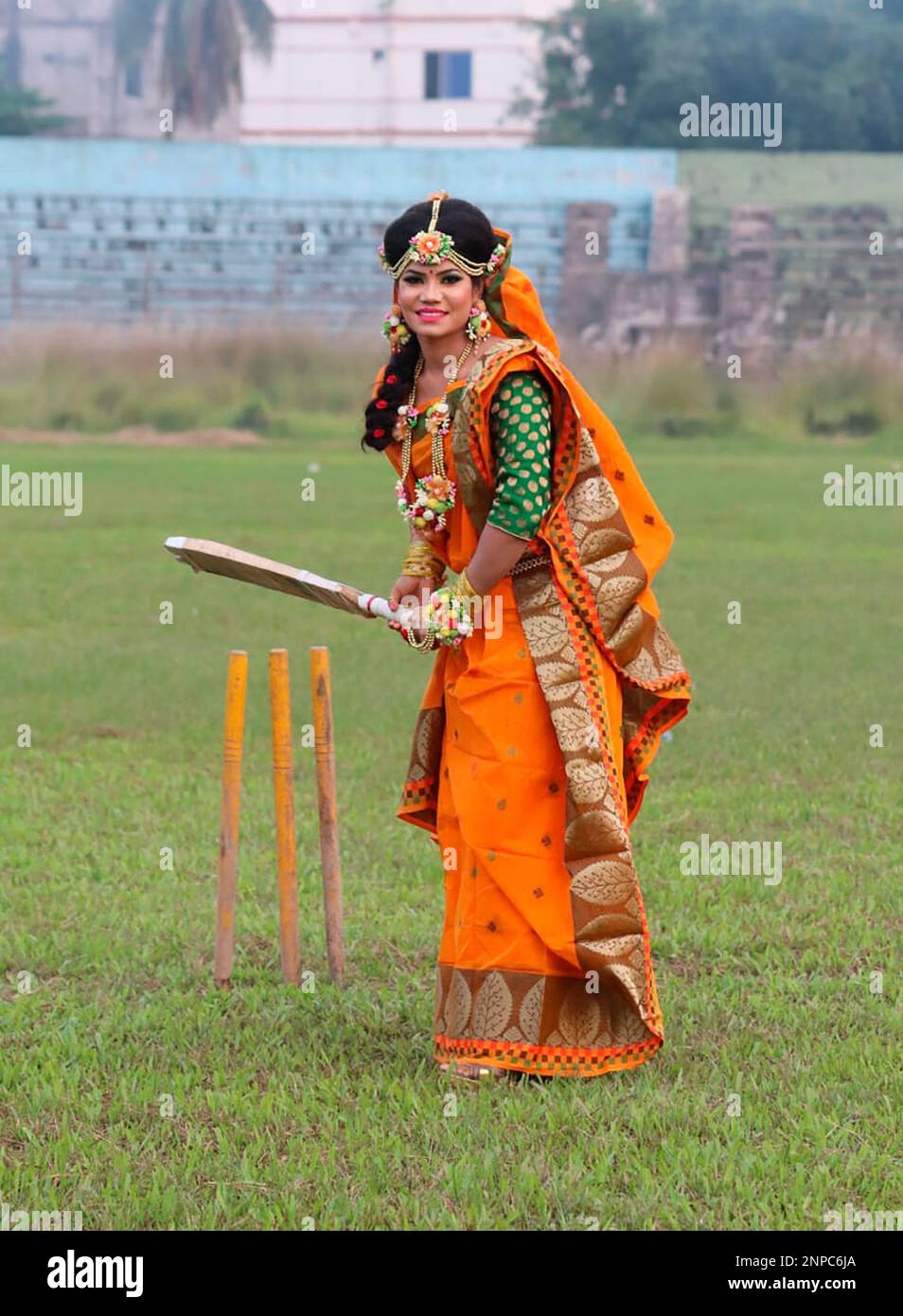 Bangladeshi cricketer Sanjida Islam poses as a bride with a cricket bat, a day before her ...
