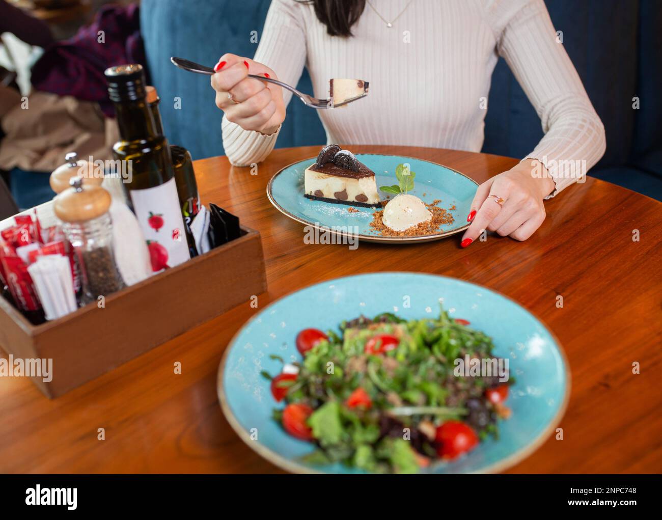 a girl without a face eats dessert in a cafe Stock Photo - Alamy
