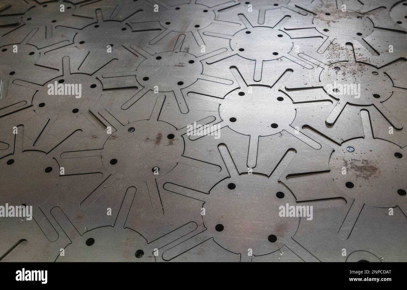 Steel sheet in which parts are laser cut Stock Photo - Alamy
