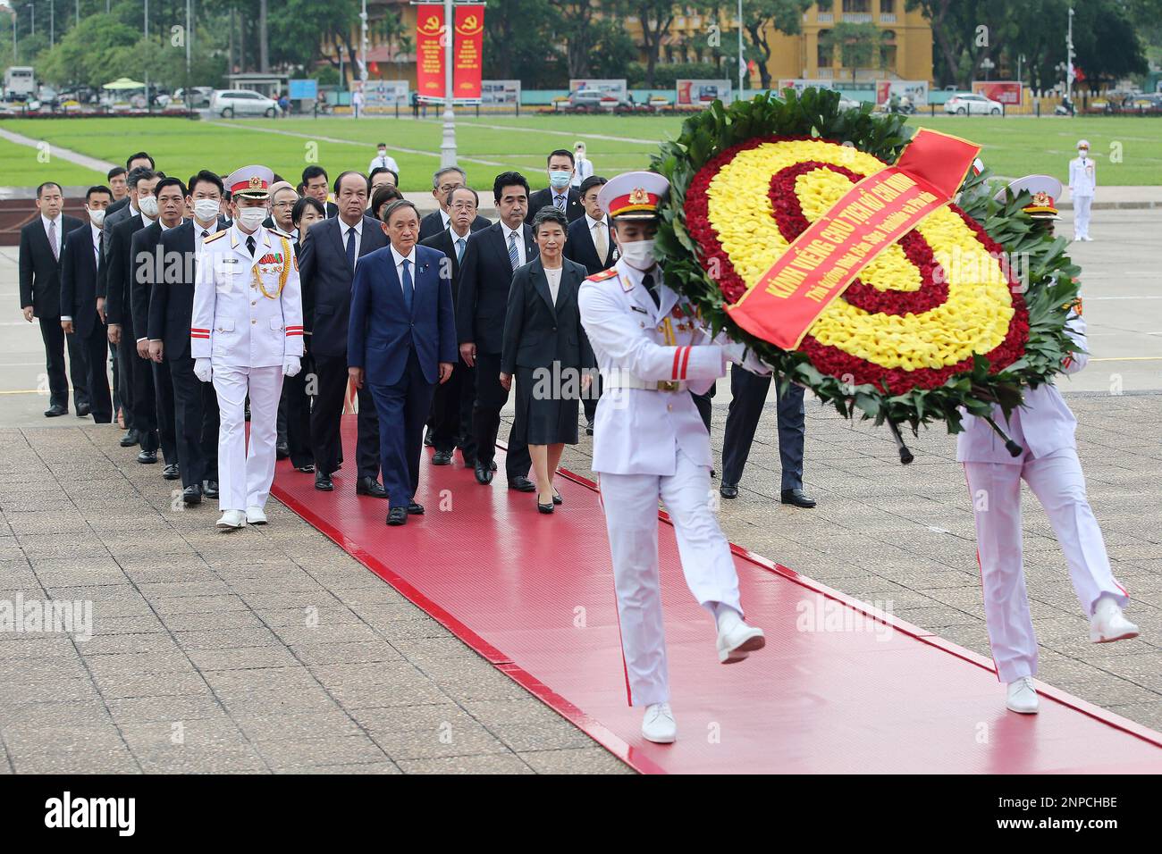 Japanese Prime Minister Yoshihide Suga, center left, and his wife ...