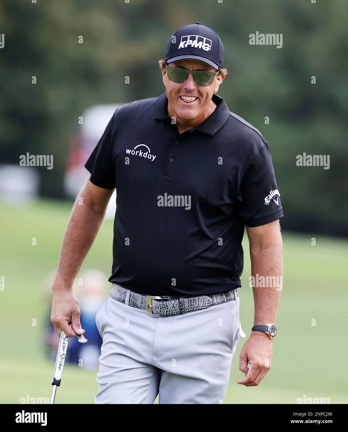 Winner Phil Mickelson walks up 18th green during final round play in ...