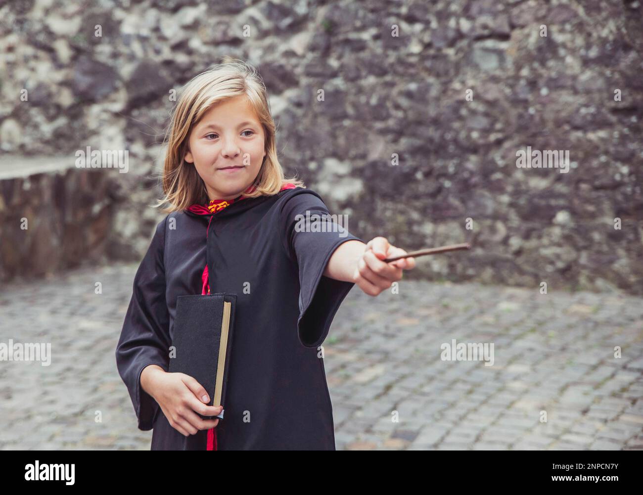 young sorceress in the castle conjuring by magic wand Stock Photo - Alamy