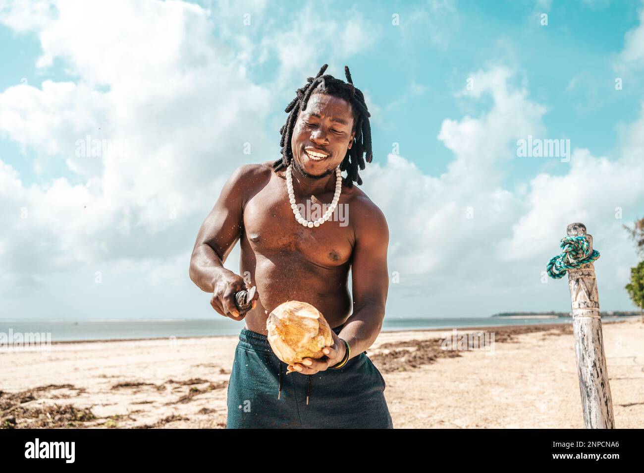 Kenyan people with coconut at the beach with typical local clothes ...