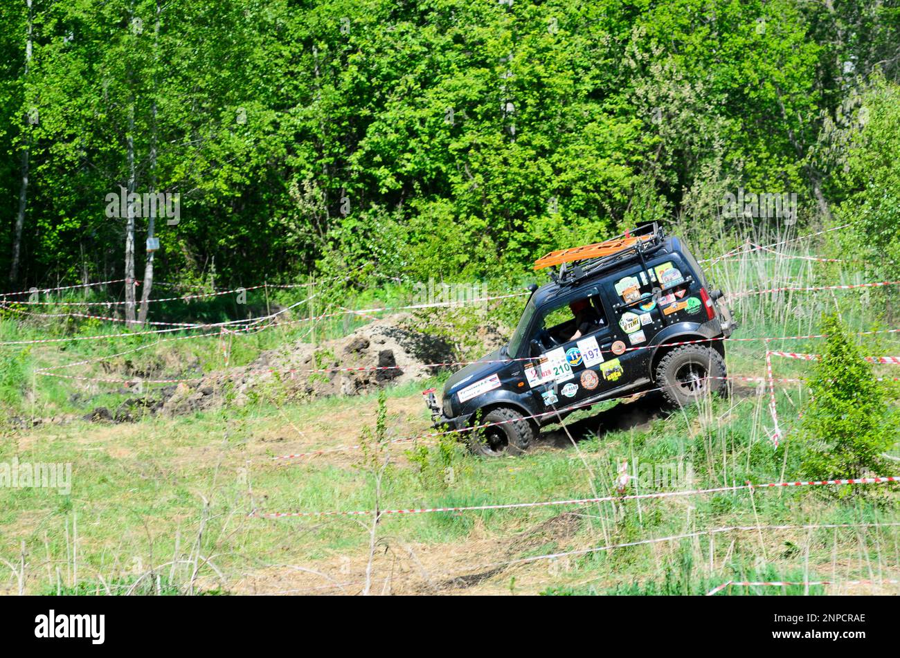 Crowd of spectators looking at the car "Suzuki Escudo" which is highly ...