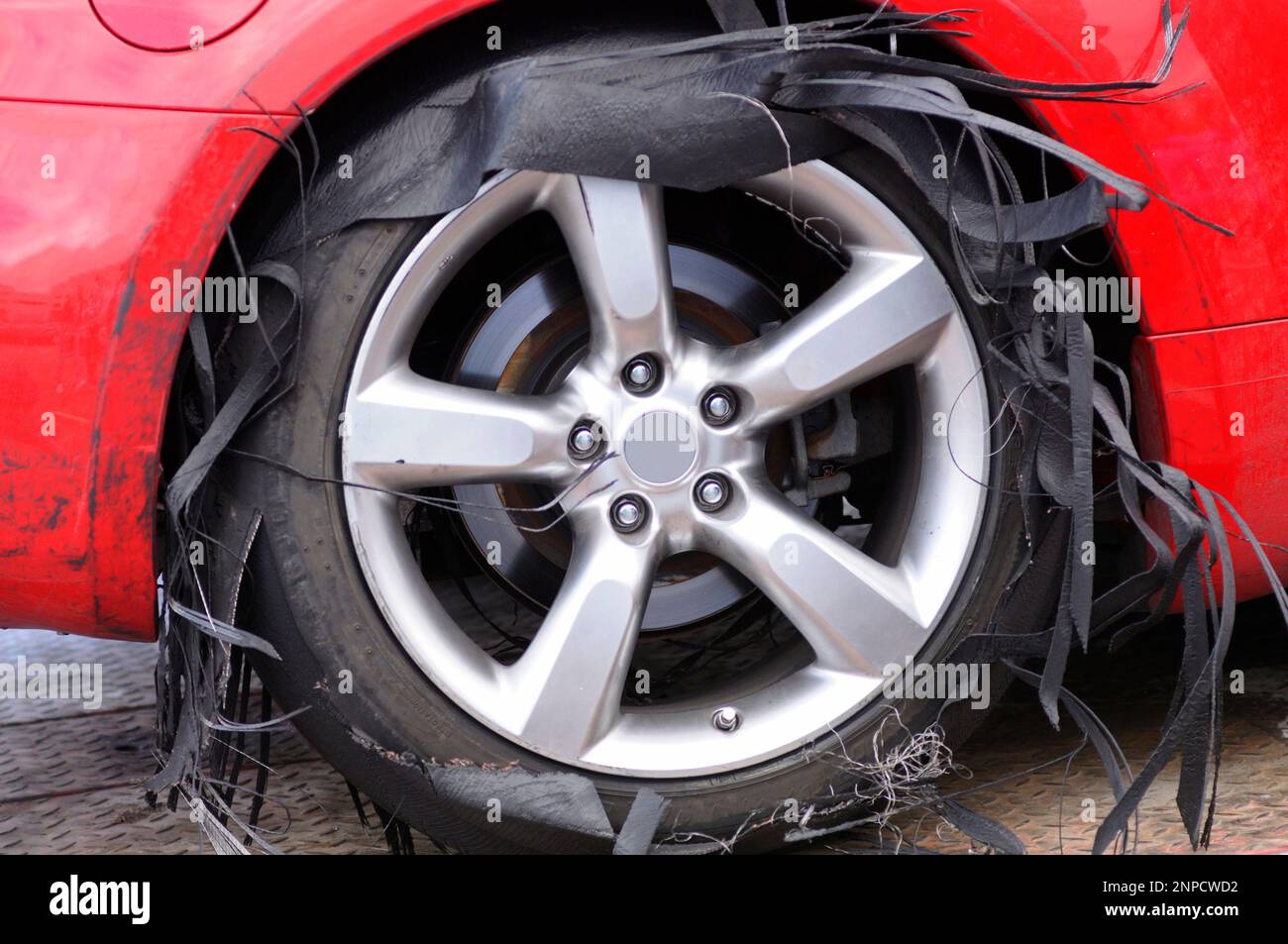 Torn tyre of a damaged sport car after race Stock Photo - Alamy
