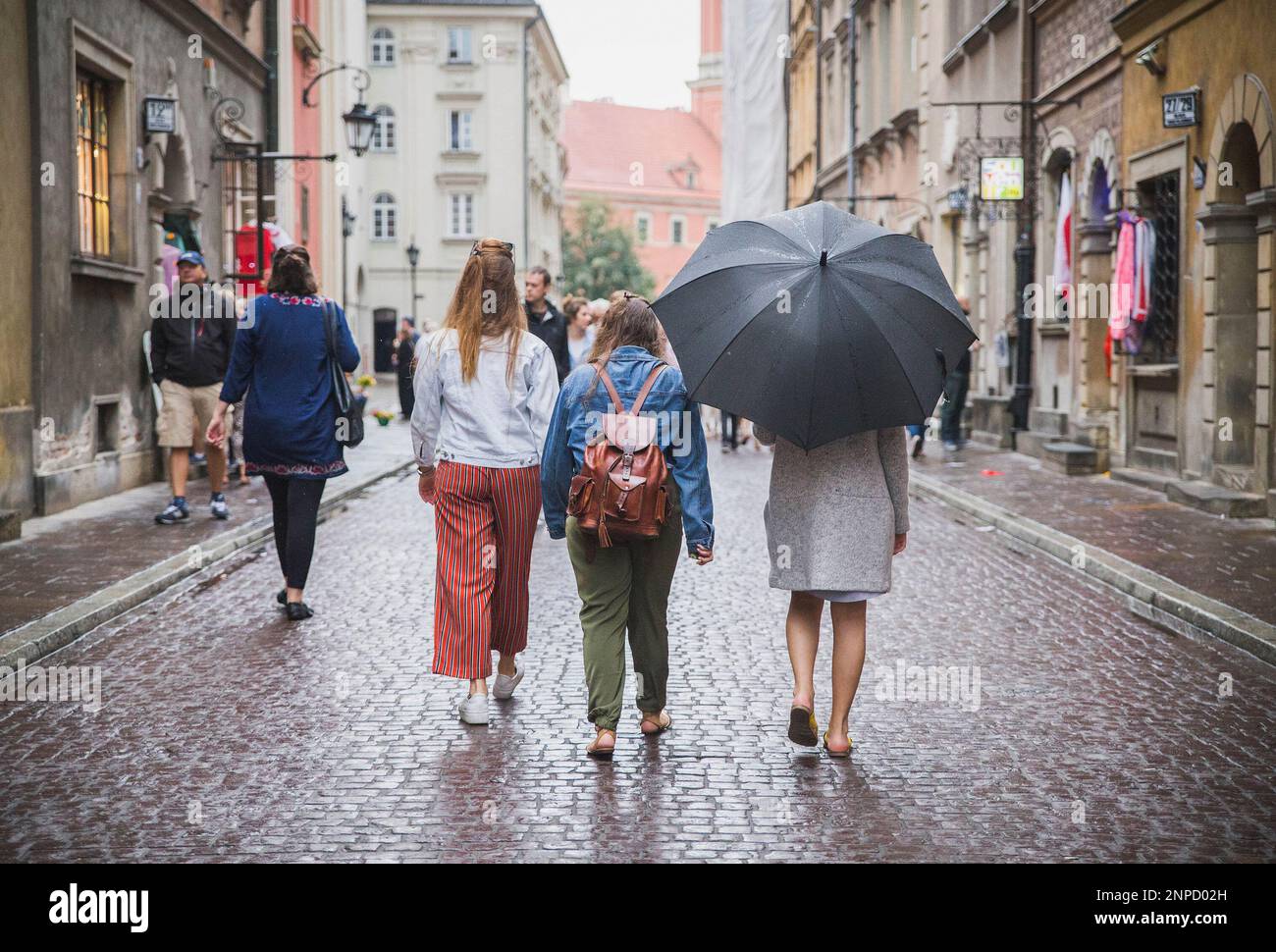 Three girls walk in rainy Warsaw Stock Photo - Alamy