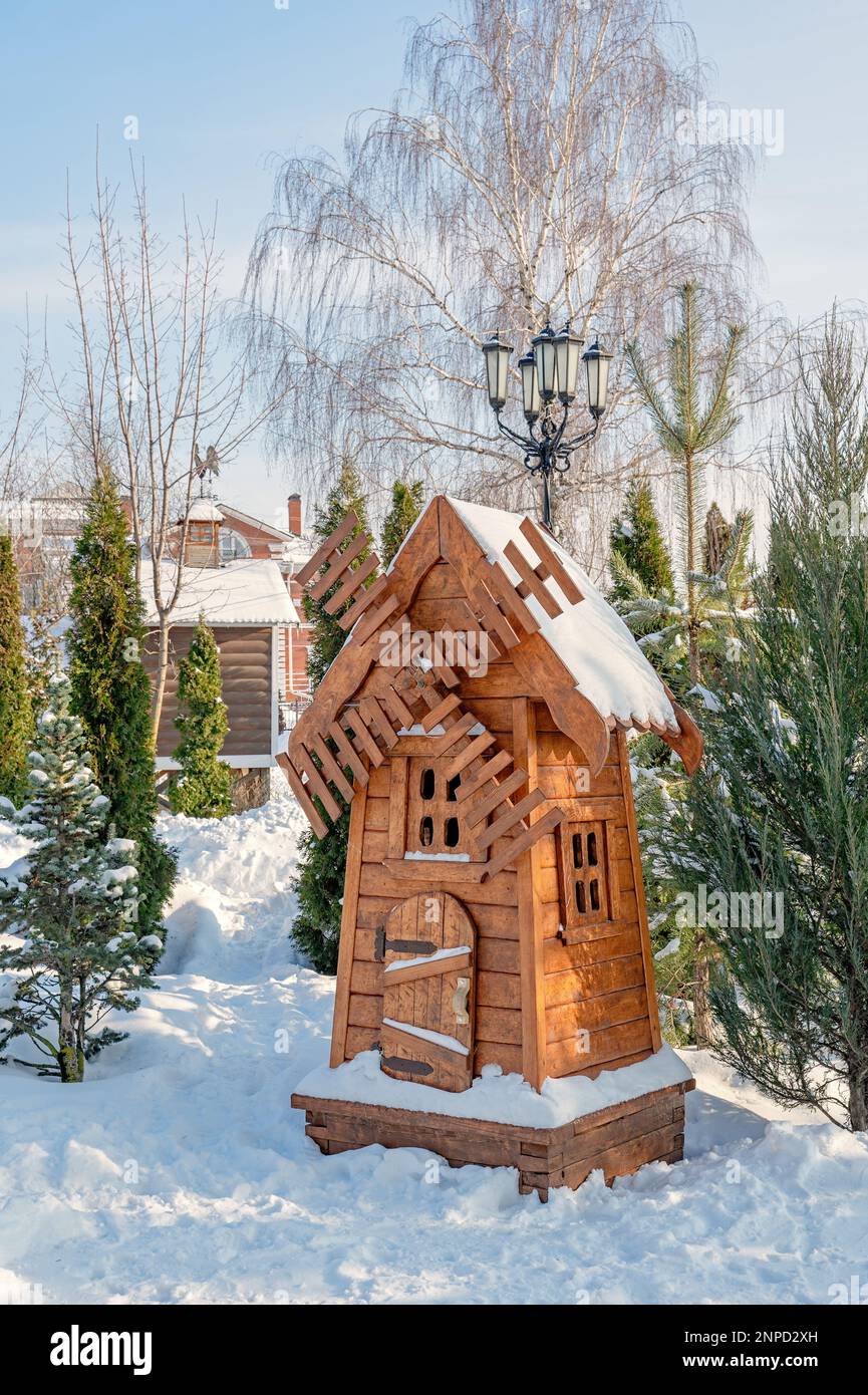 Wooden windmill as a decoration on the street. An old small old wooden ...