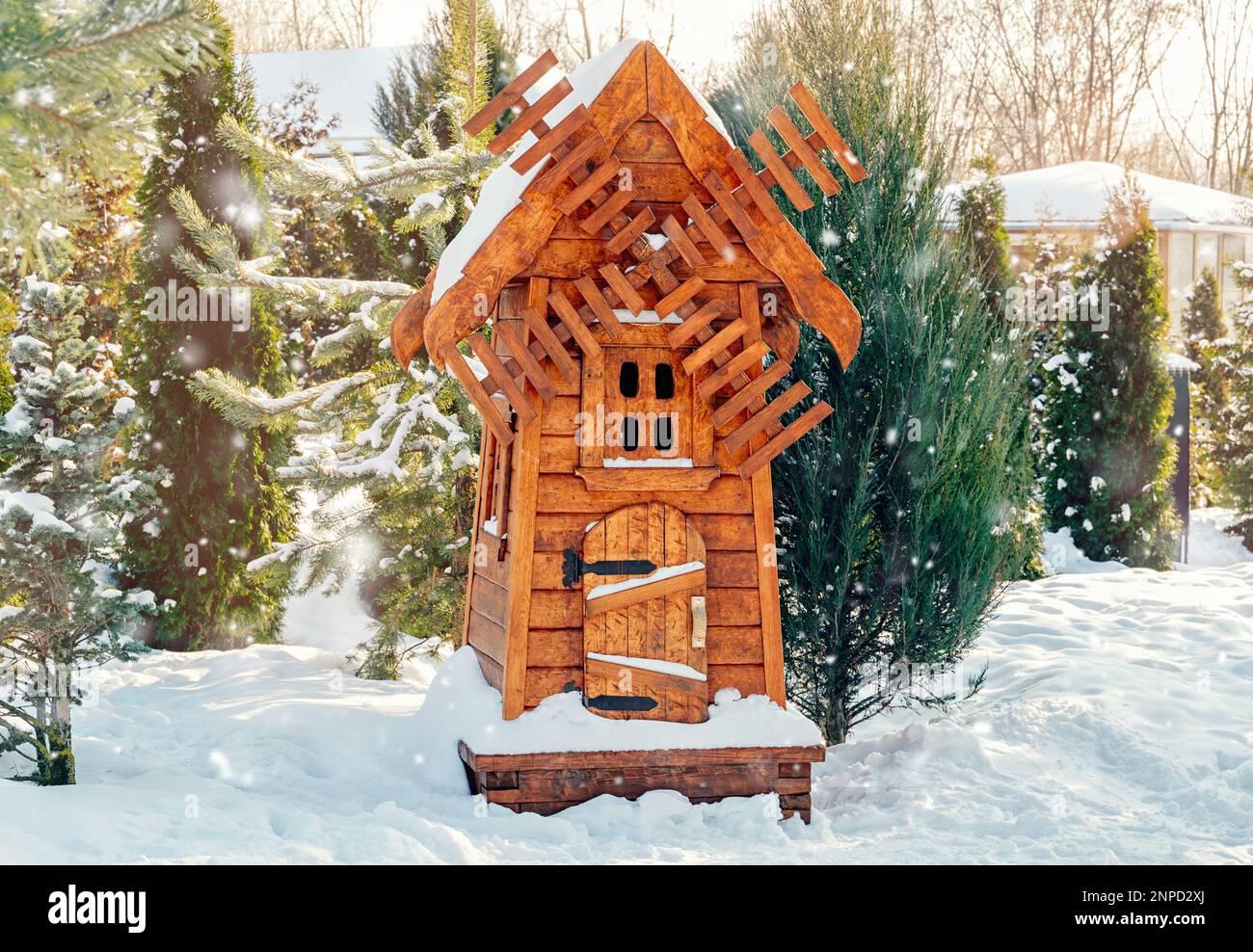 Wooden windmill as a decoration on the street. An old small old wooden ...