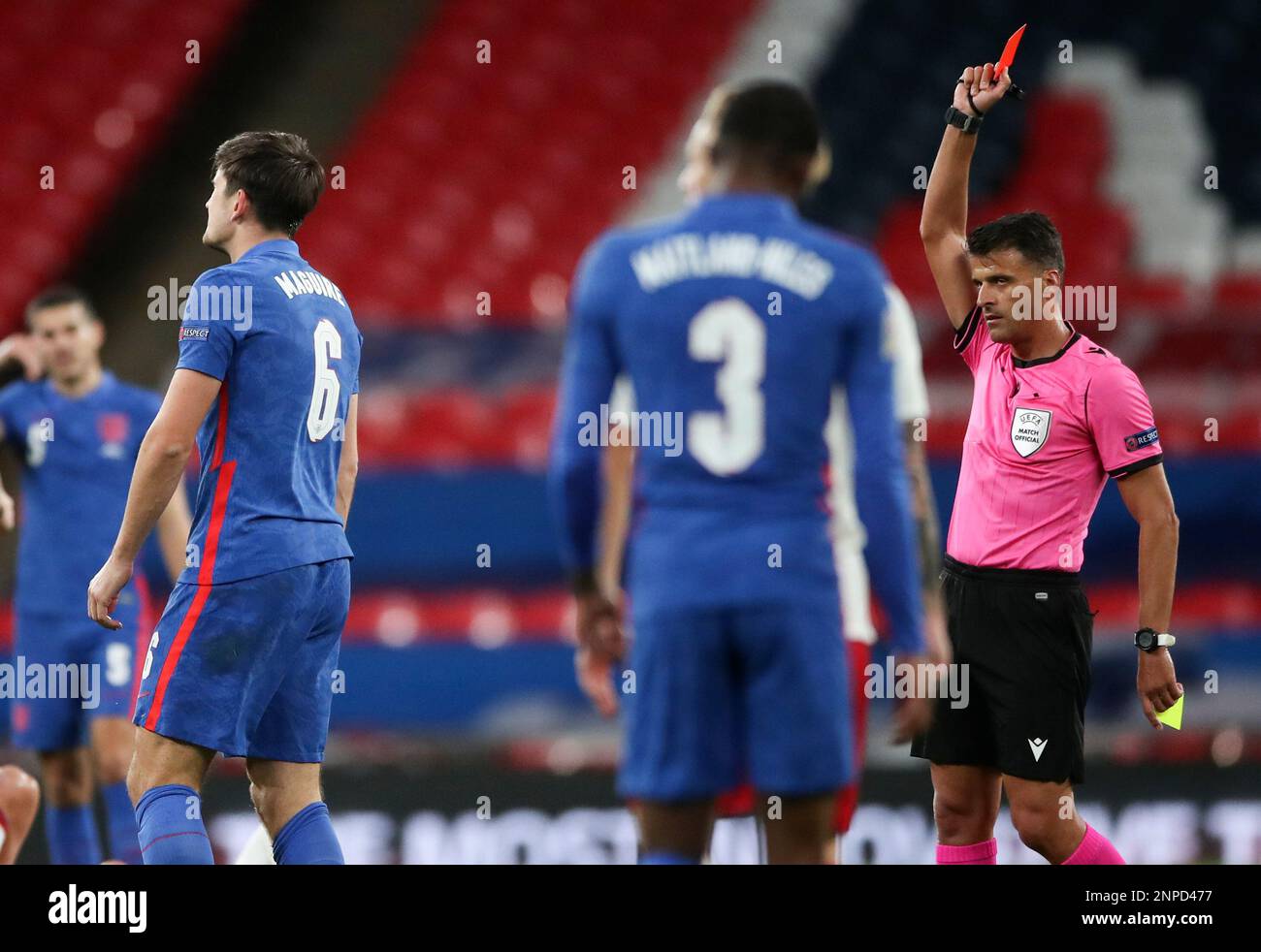 Referee Jesus Gil Manzano, right, shows a red card to England's Harry ...