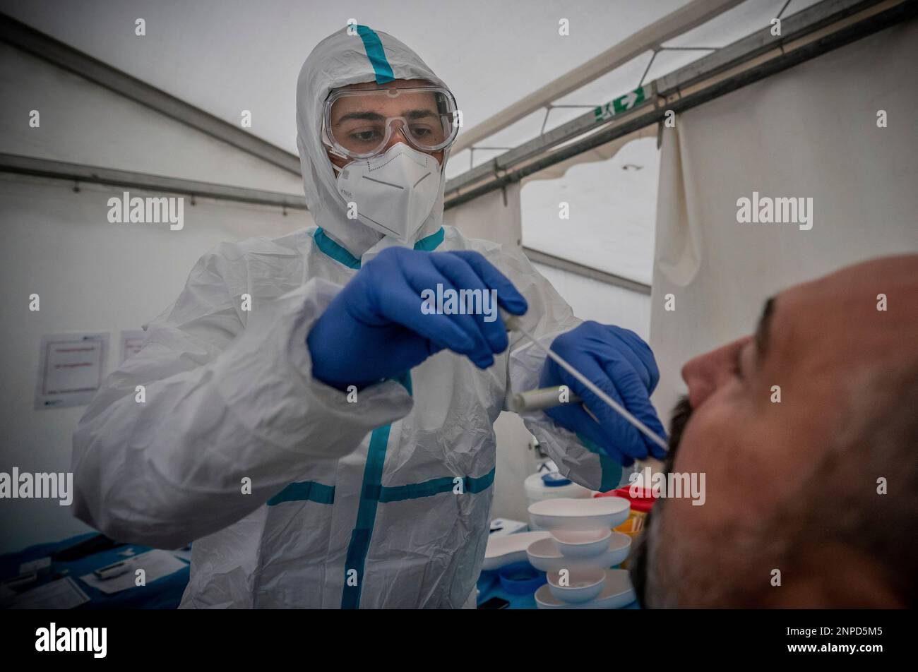 Medical personnel perform a Covid-19 PCR smear on a man at a corona ...