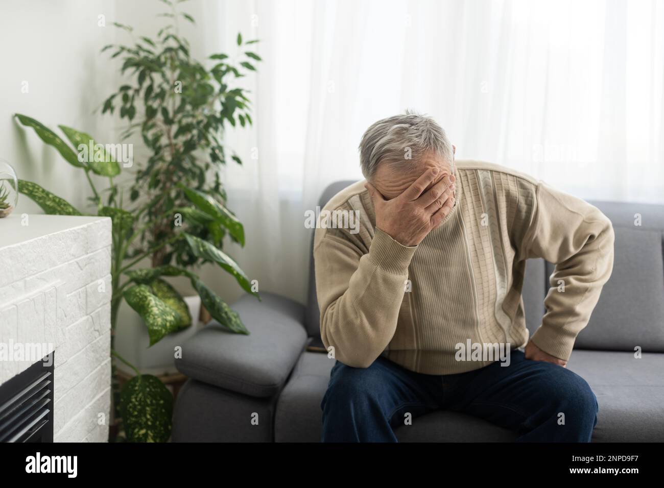 Stressed senior man massaging temples hi-res stock photography and ...