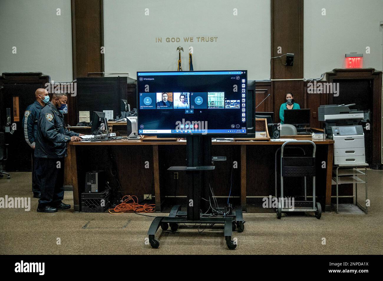 New York Police Department officers listen as Judge Edwin Novillo, left ...