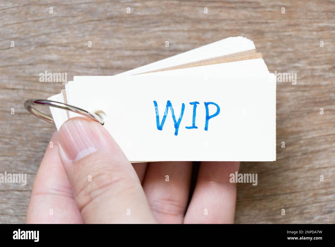 Hand hold flash card with handwriting in word WIP (Abbreviation of work ...