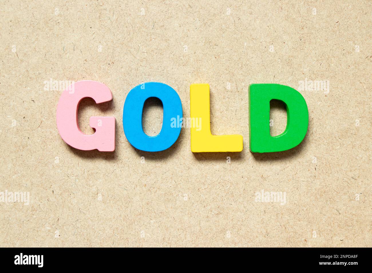 Color alphabet letter in word gold on wood background Stock Photo - Alamy