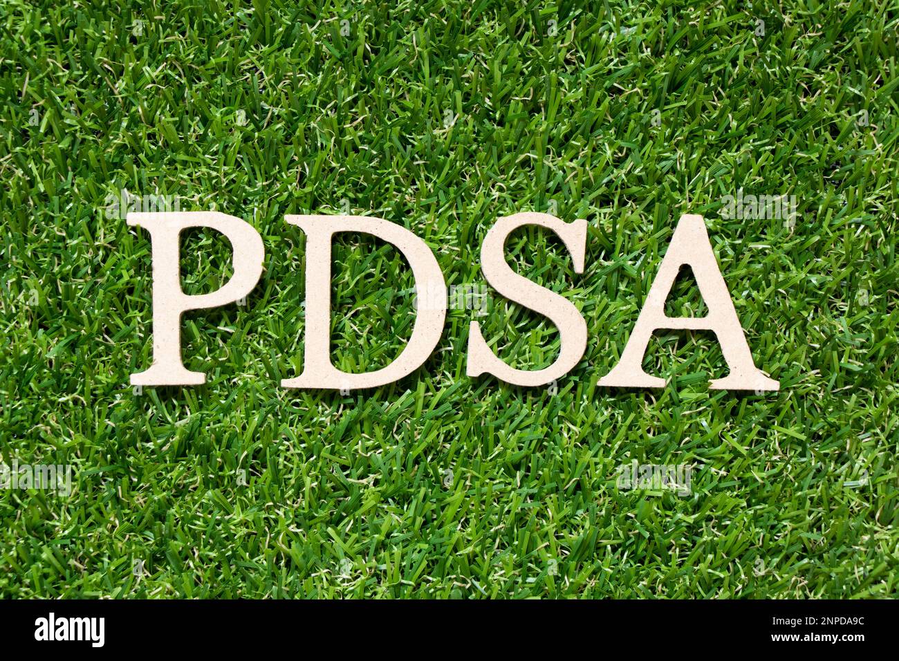 Wood alphabet letter in word PDSA (Abbreviation of plan do study act ...