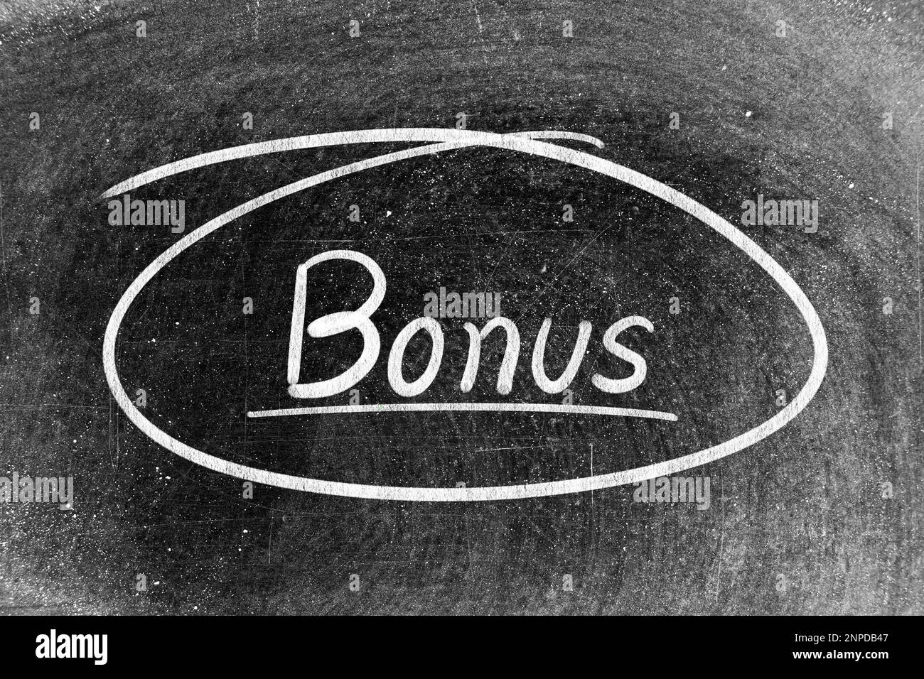 White chalk hand writing in word bonus and circle shape on blackboard ...