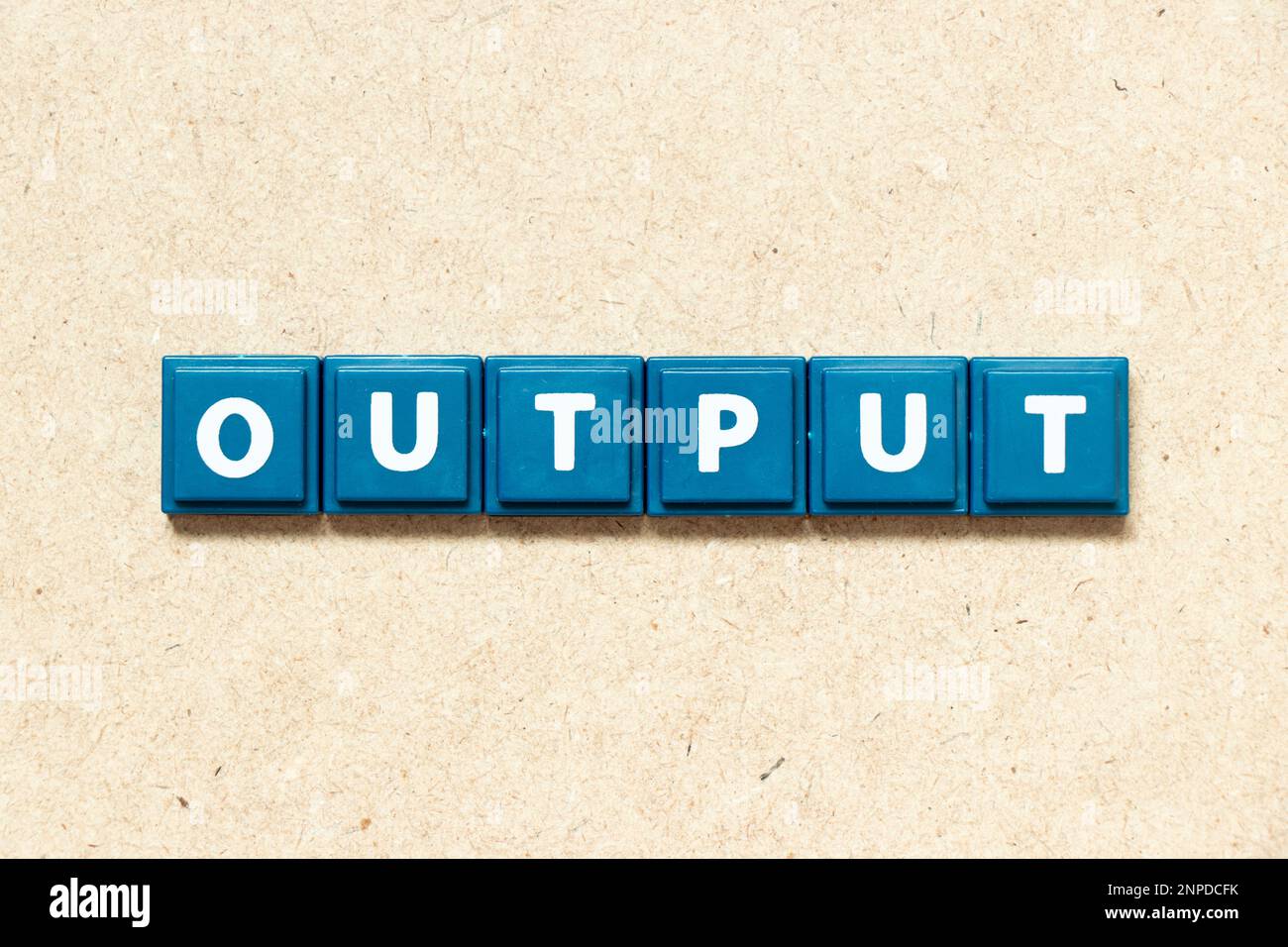 Tile alphabet letter in word output on wood background Stock Photo - Alamy