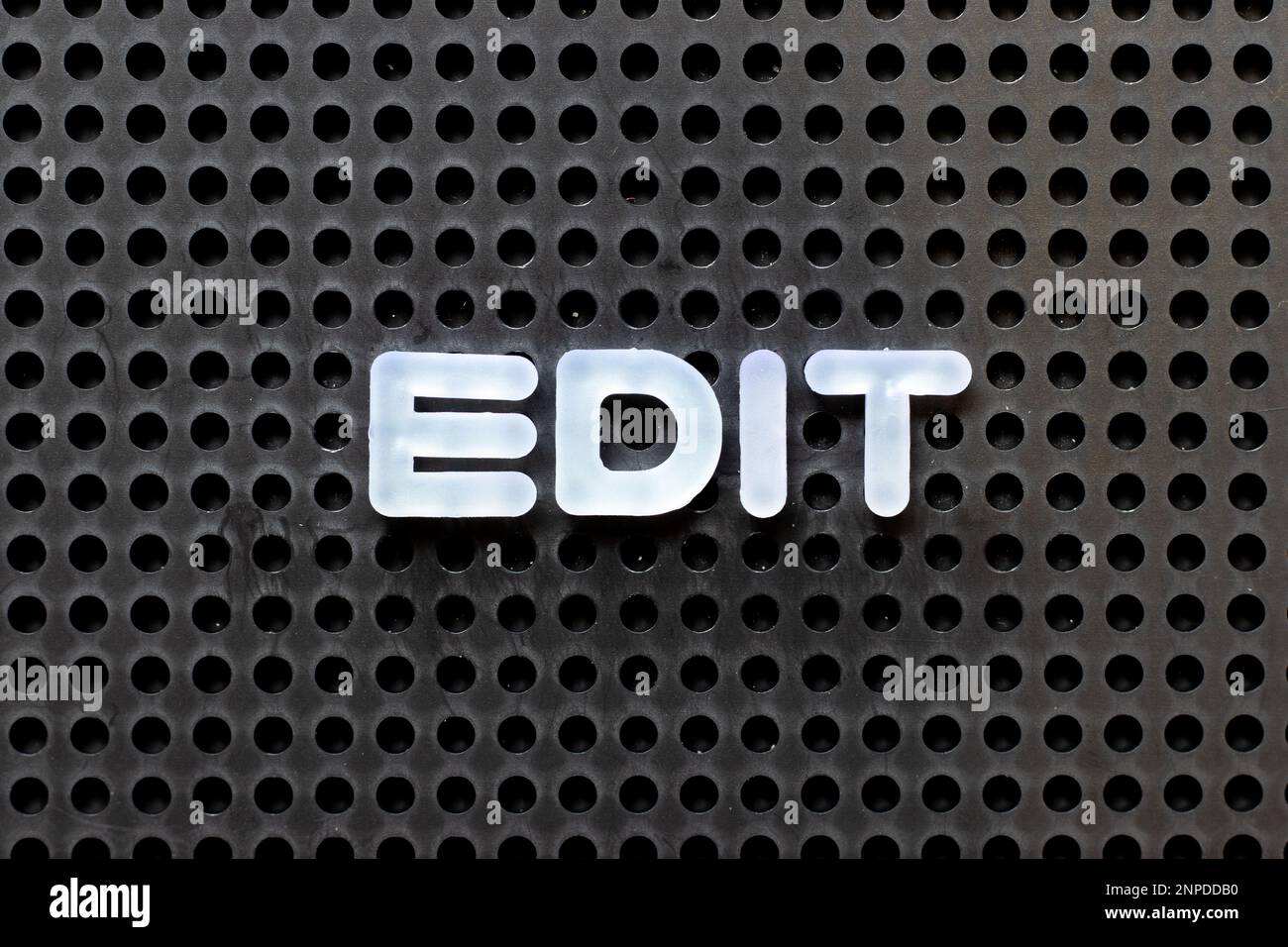 White color alphabet with word edit on black pegboard background Stock ...