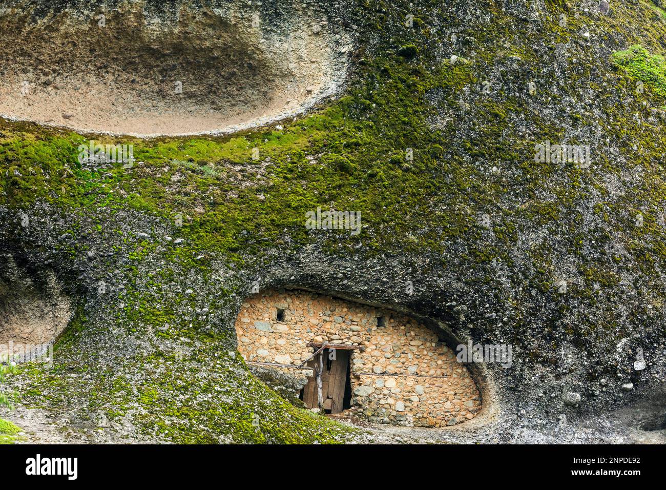 An abandoned monastic cave house in the cliff at Meteora in northern ...