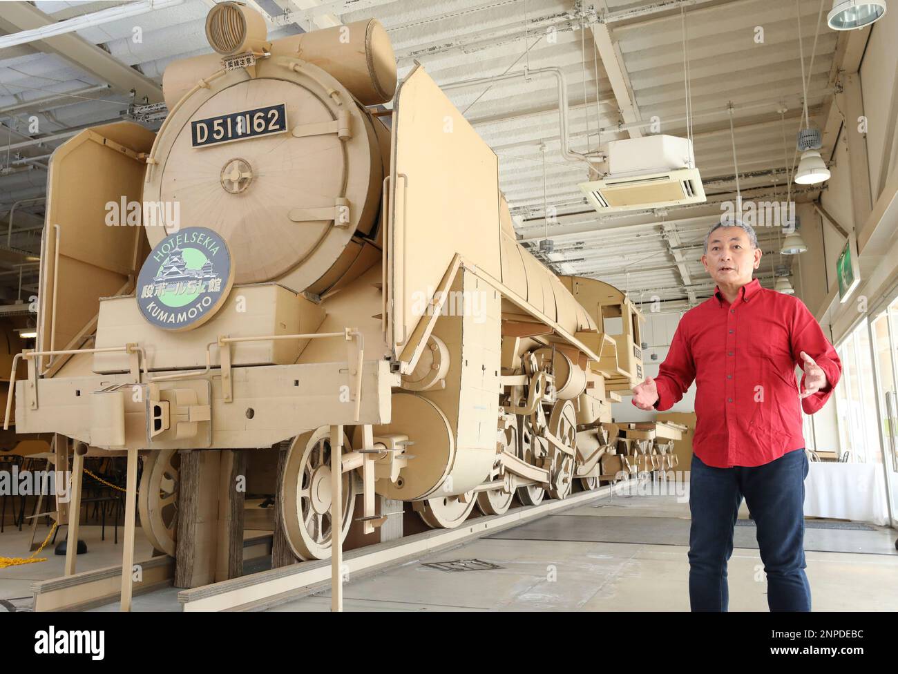 A photo shows a full-scale cardboard steam locomotive (SL) in Nankan ...