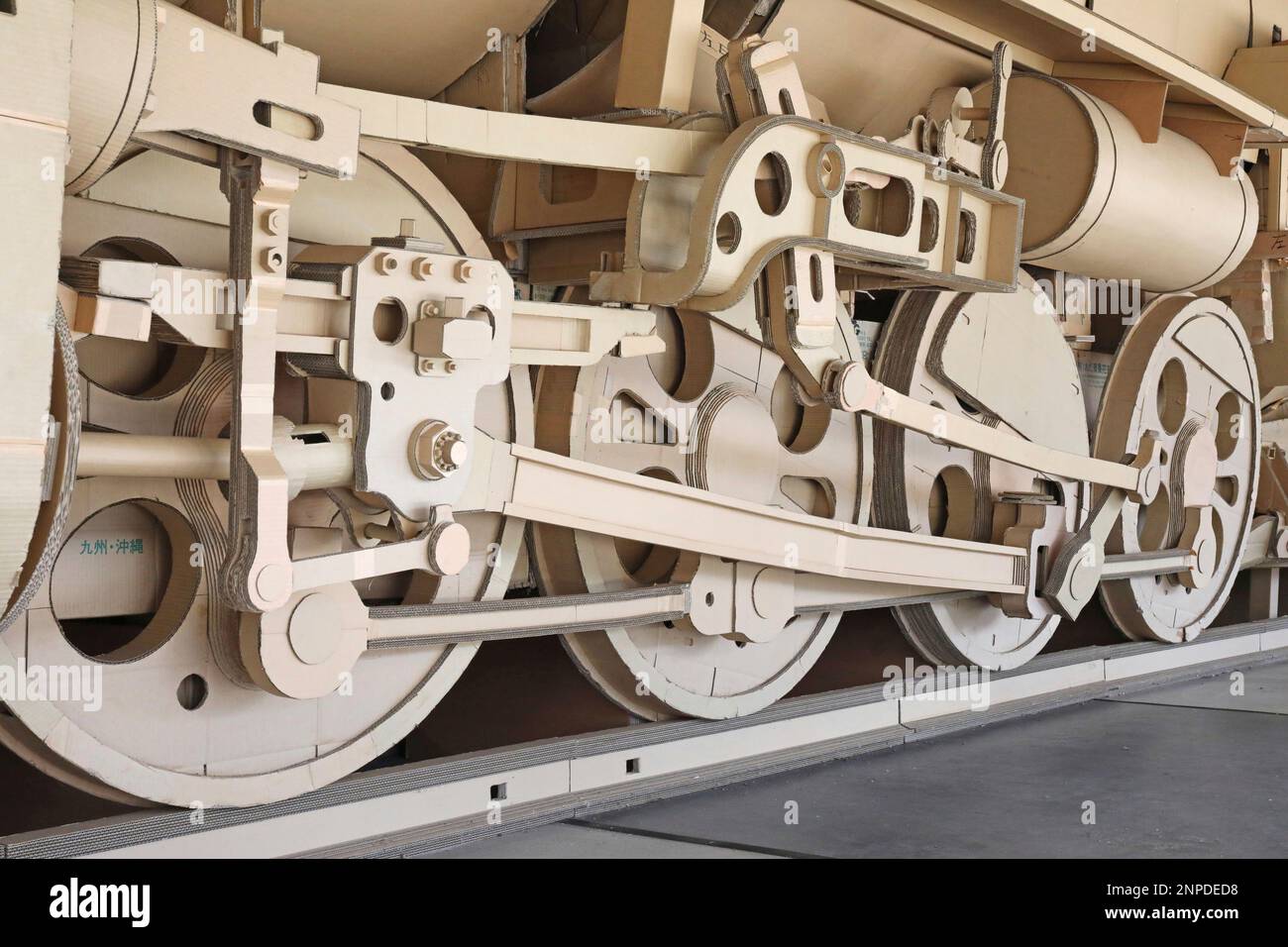 A photo shows a full-scale cardboard steam locomotive (SL) in Nankan ...
