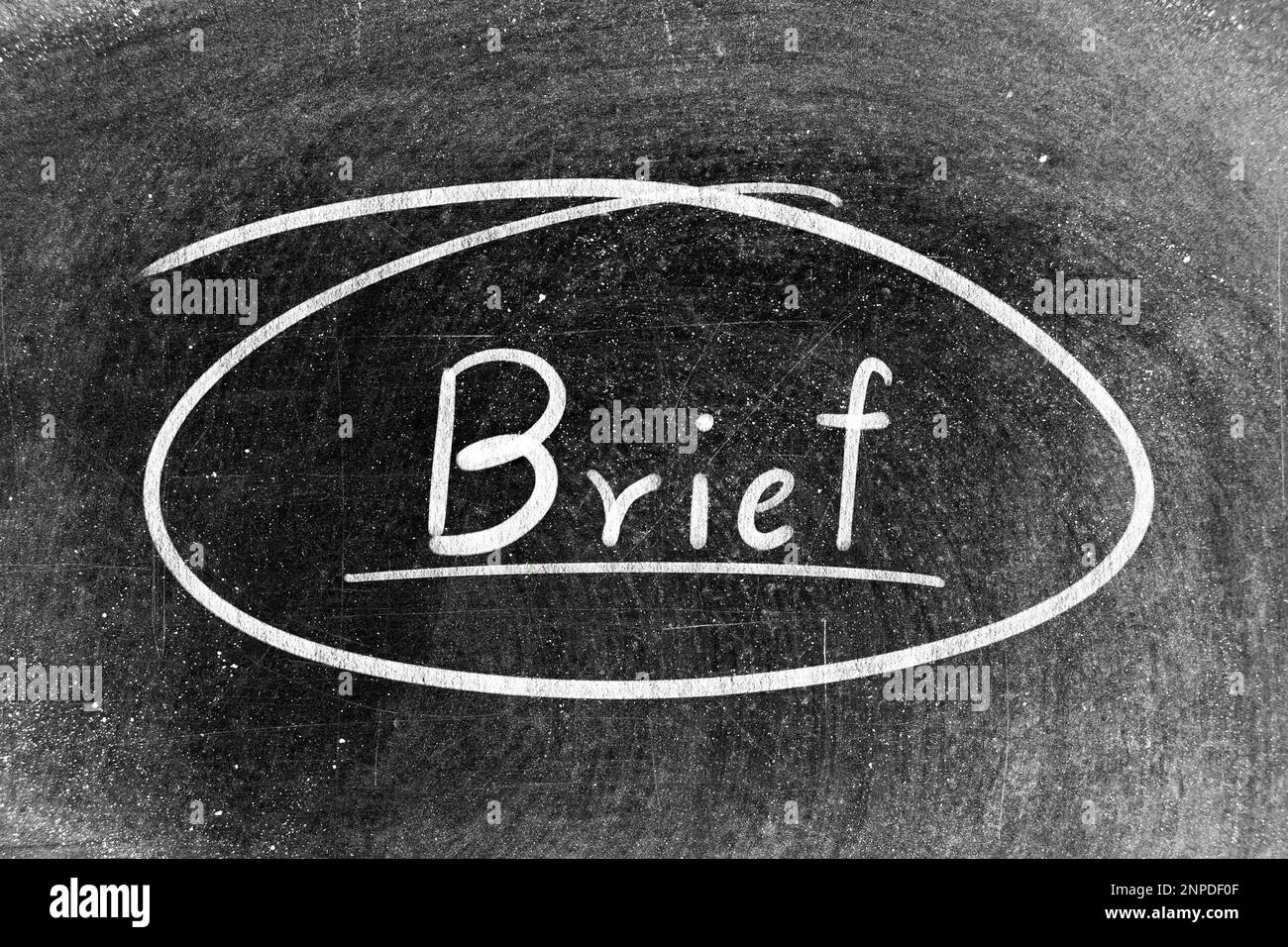 White chalk hand writing in word brief and circle shape on blackboard ...