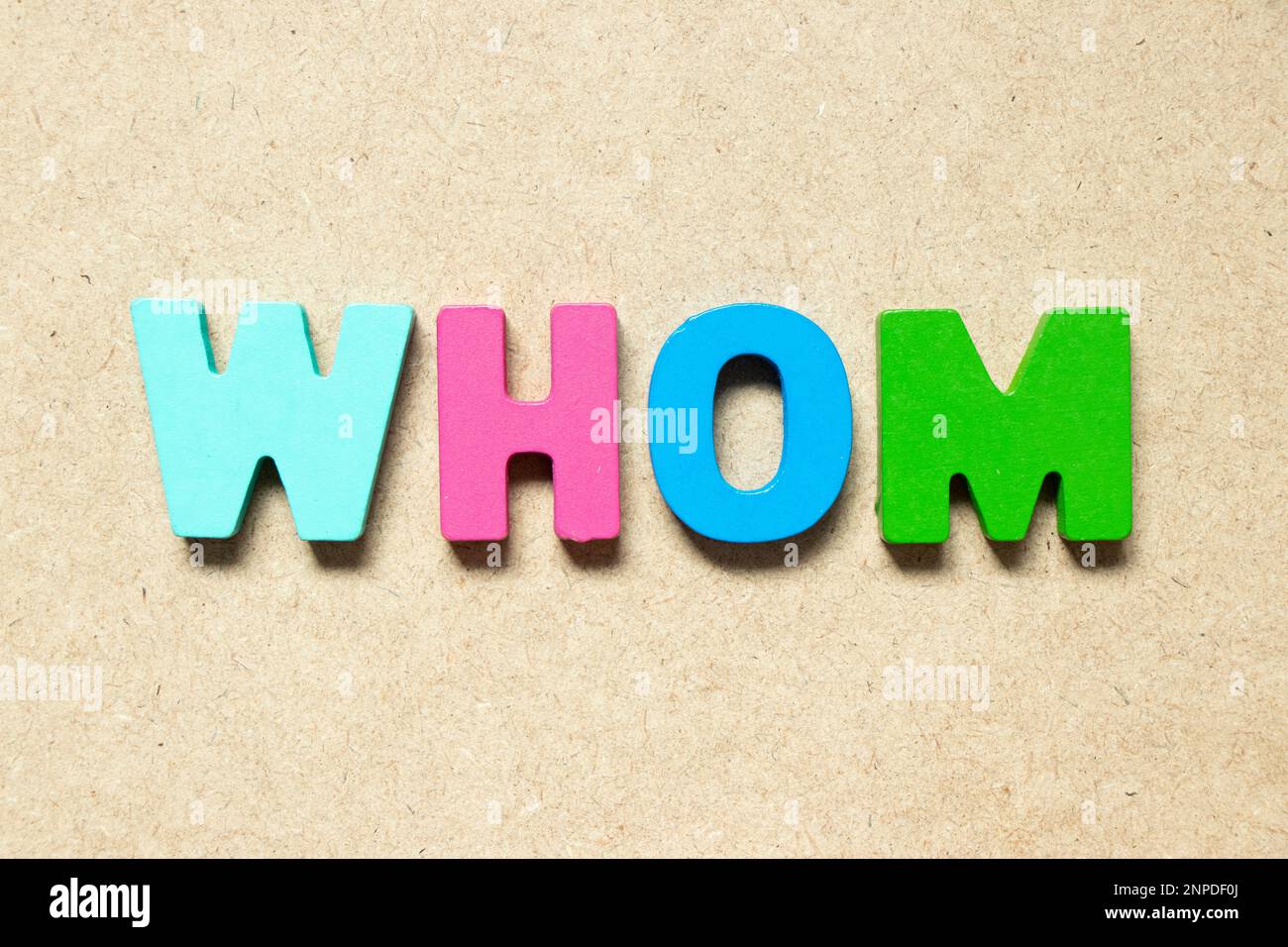 Color alphabet letter in word whom on wood background Stock Photo - Alamy
