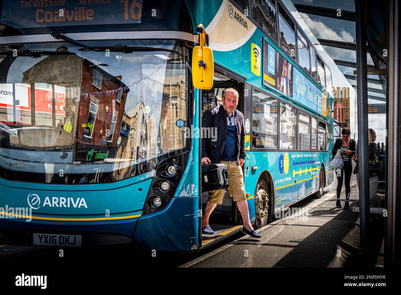 A man alights from a bus Stock Photo - Alamy