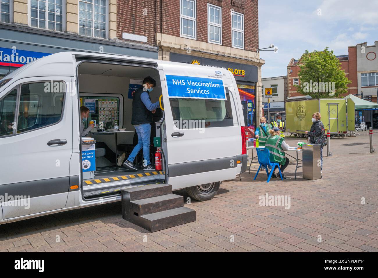 A mobile NHS vaccination van in a town centre Stock Photo - Alamy