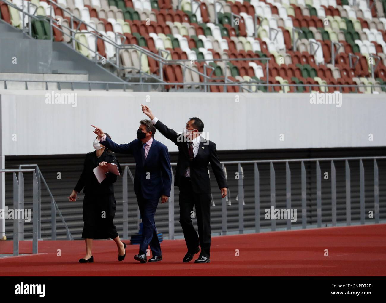 World Athletics President Sebastian Coe, center, wearing a protective ...