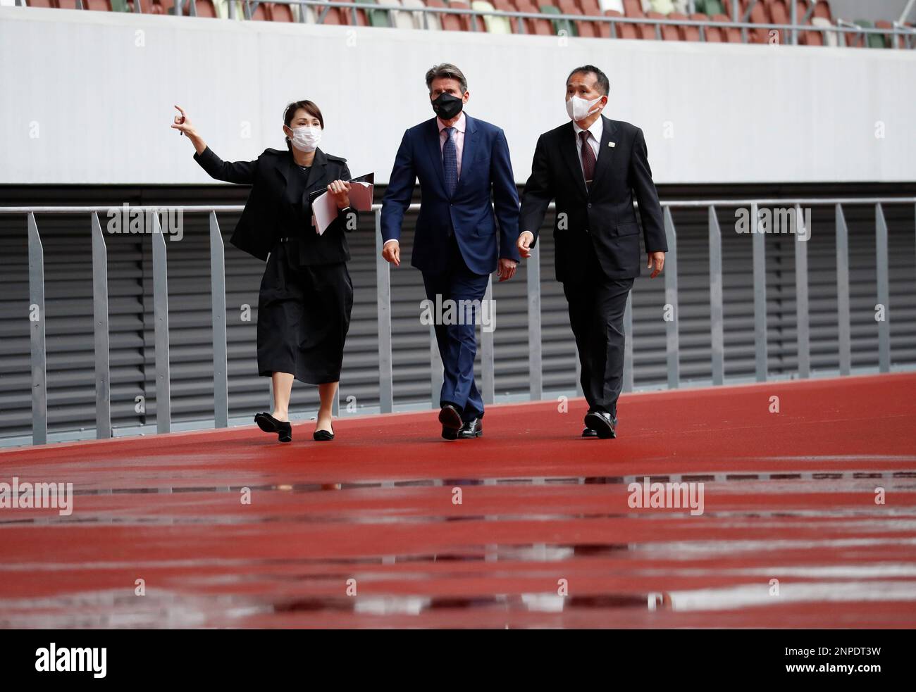 World Athletics President Sebastian Coe, center, wearing a protective ...
