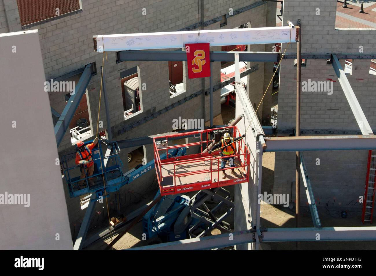 Workers lift the final beam during a topping off ceremony during ...