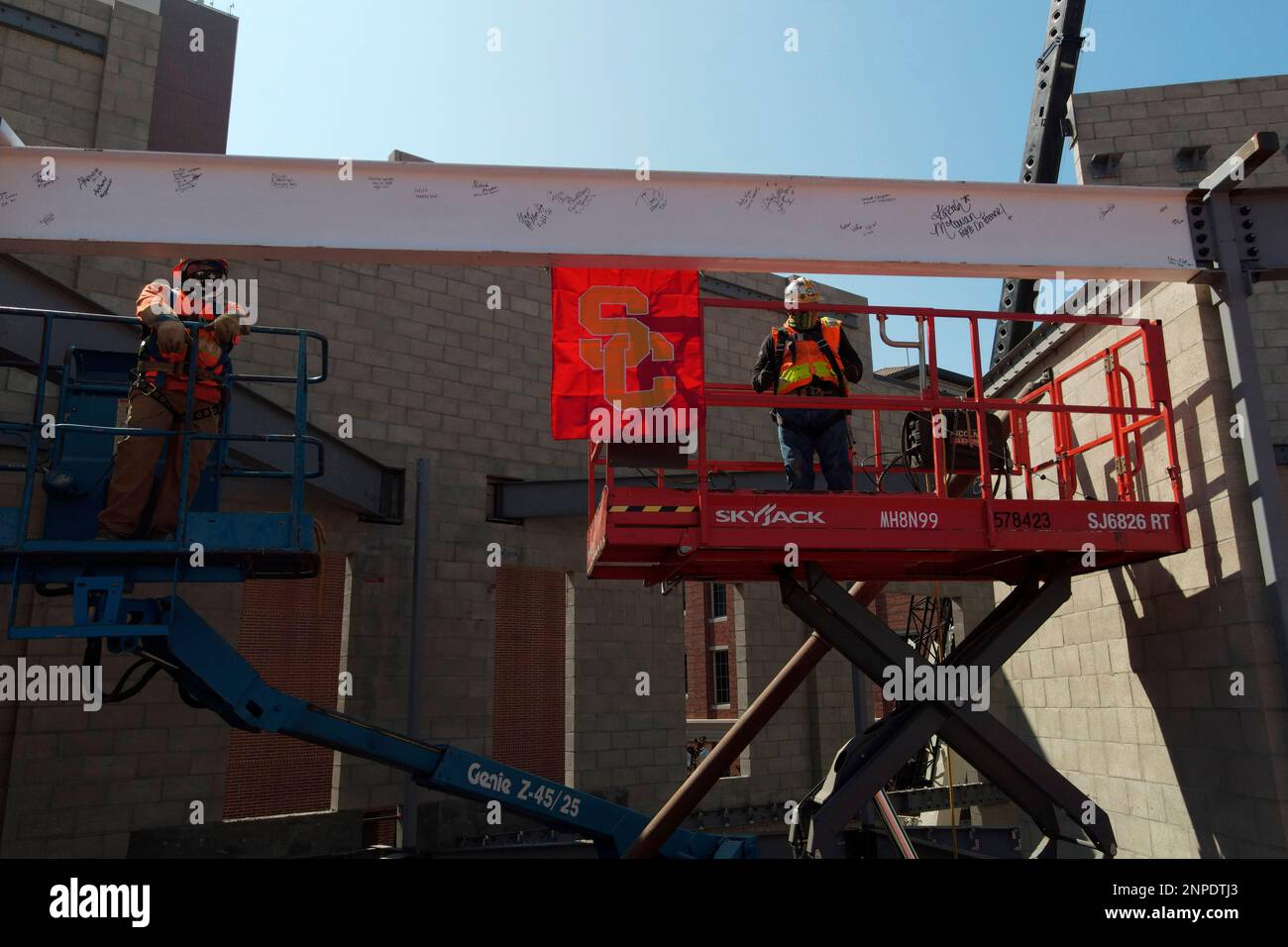 Workers lift the final beam during a topping off ceremony during ...