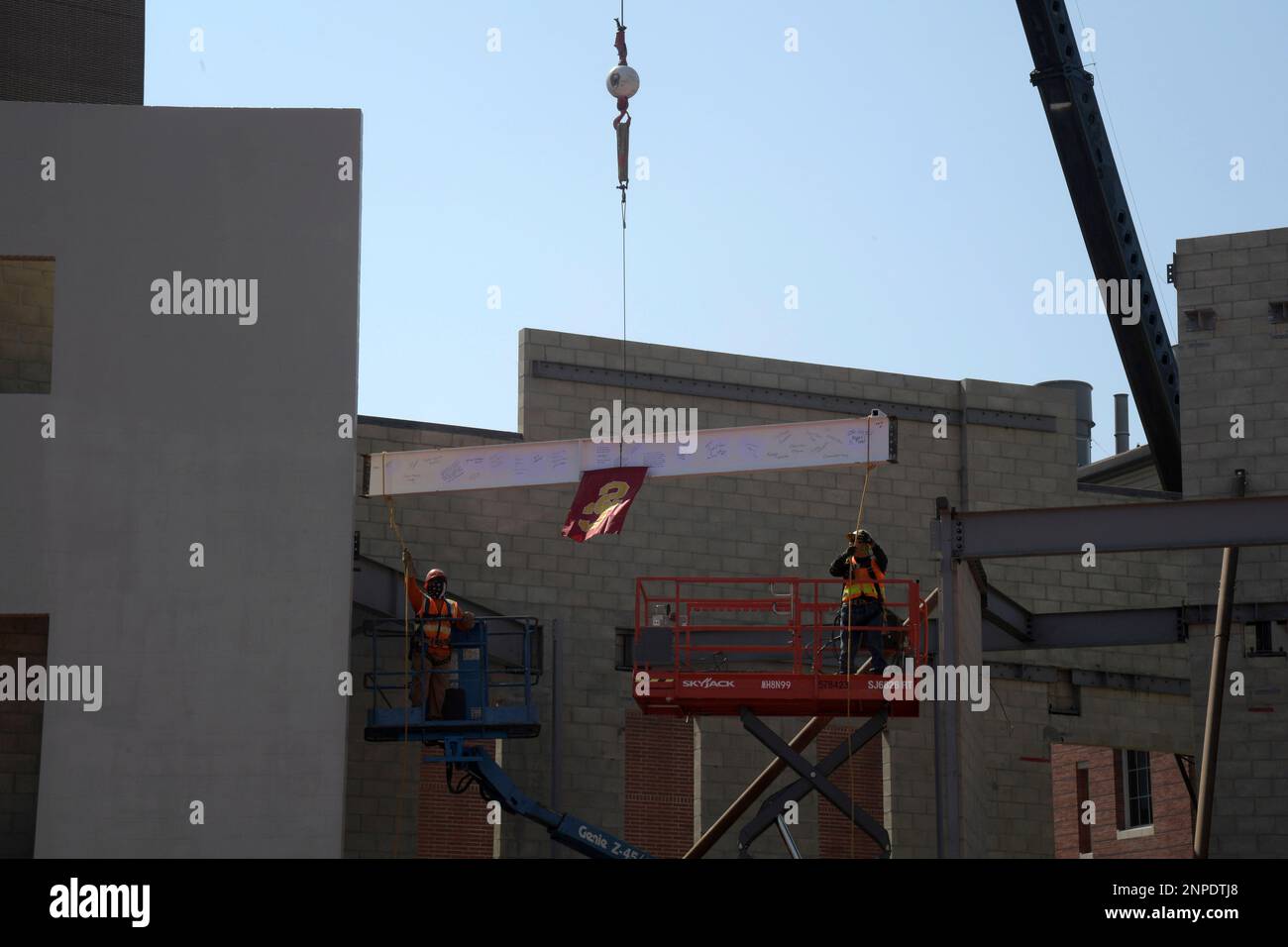 Workers lift the final beam during a topping off ceremony during ...