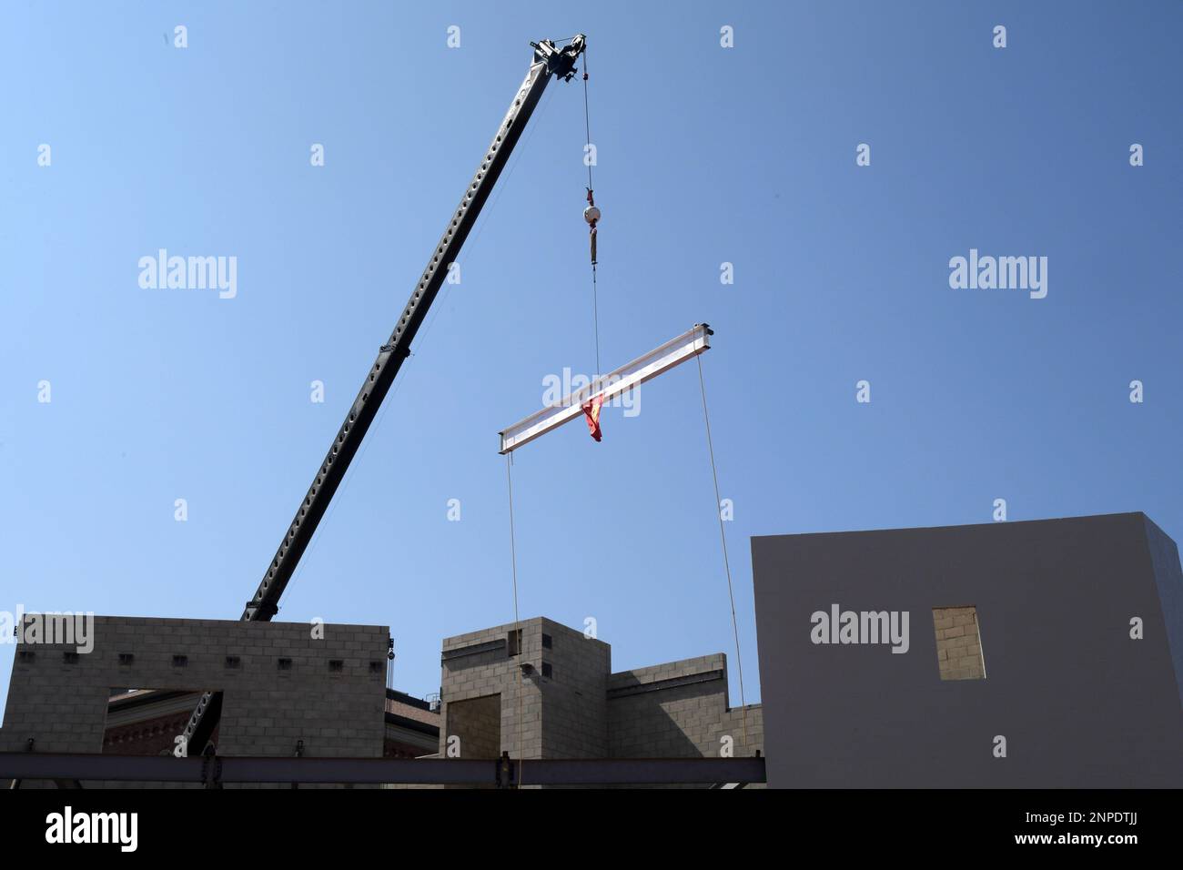 Workers lift the final beam during a topping off ceremony during ...
