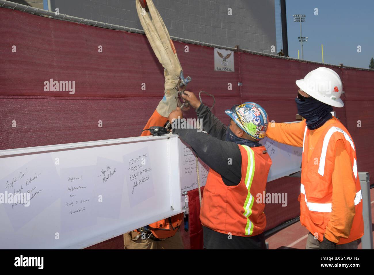 Workers lift the final beam during a topping off ceremony during ...