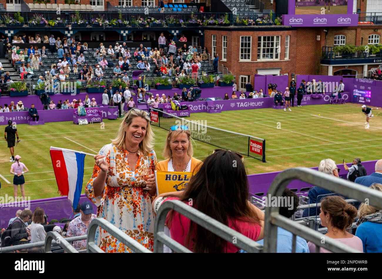 Two Dutch ladies smile for the camera holding flags during a break at ...