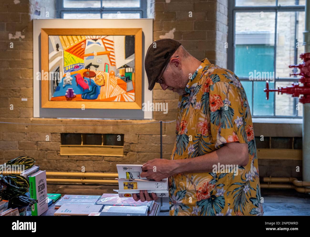 A visitor of Salt Mills in West Yorkshire looks at art books while ...